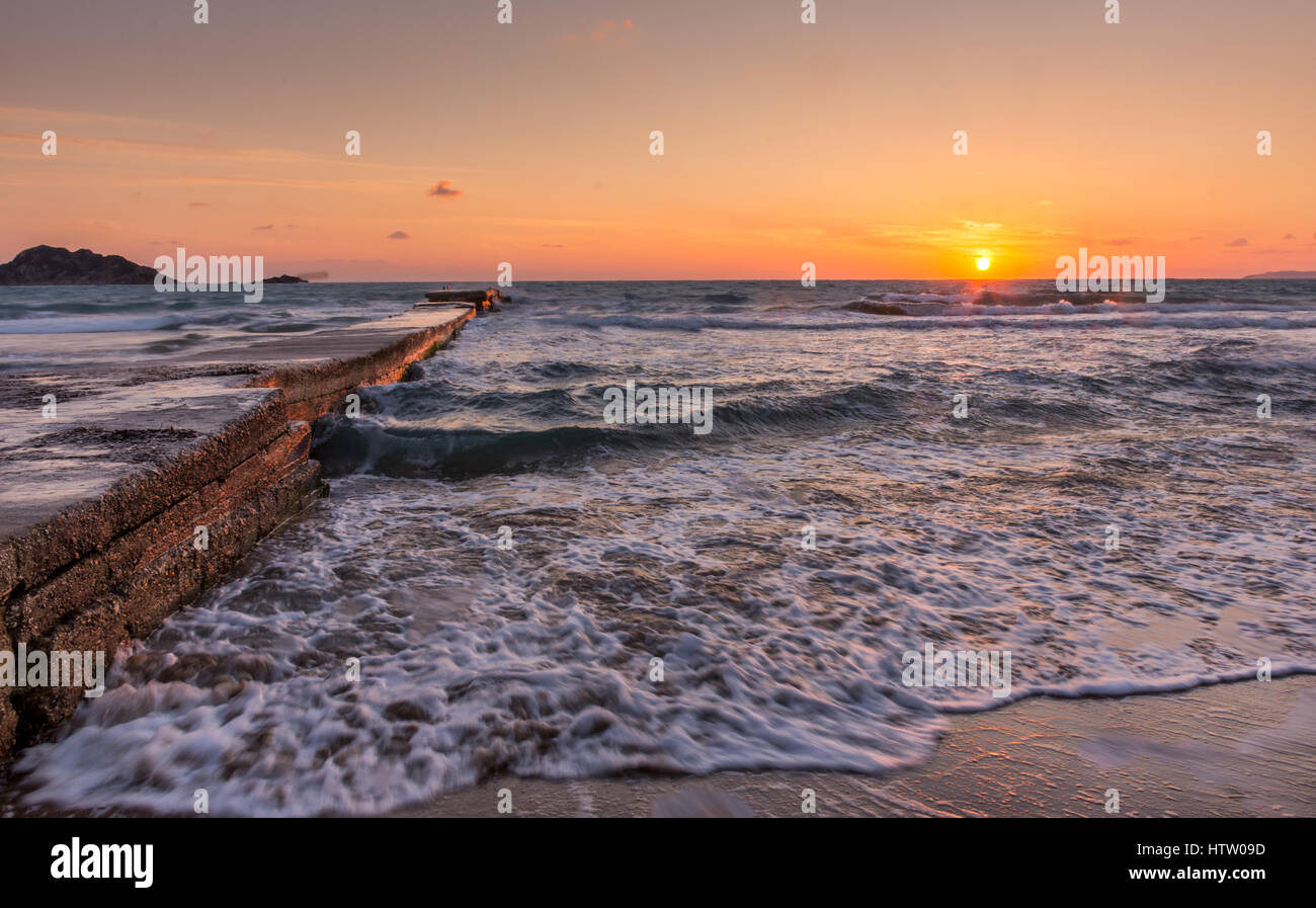 Beautiful sunset with stone pier in northern Corfu, Greece Stock Photo ...