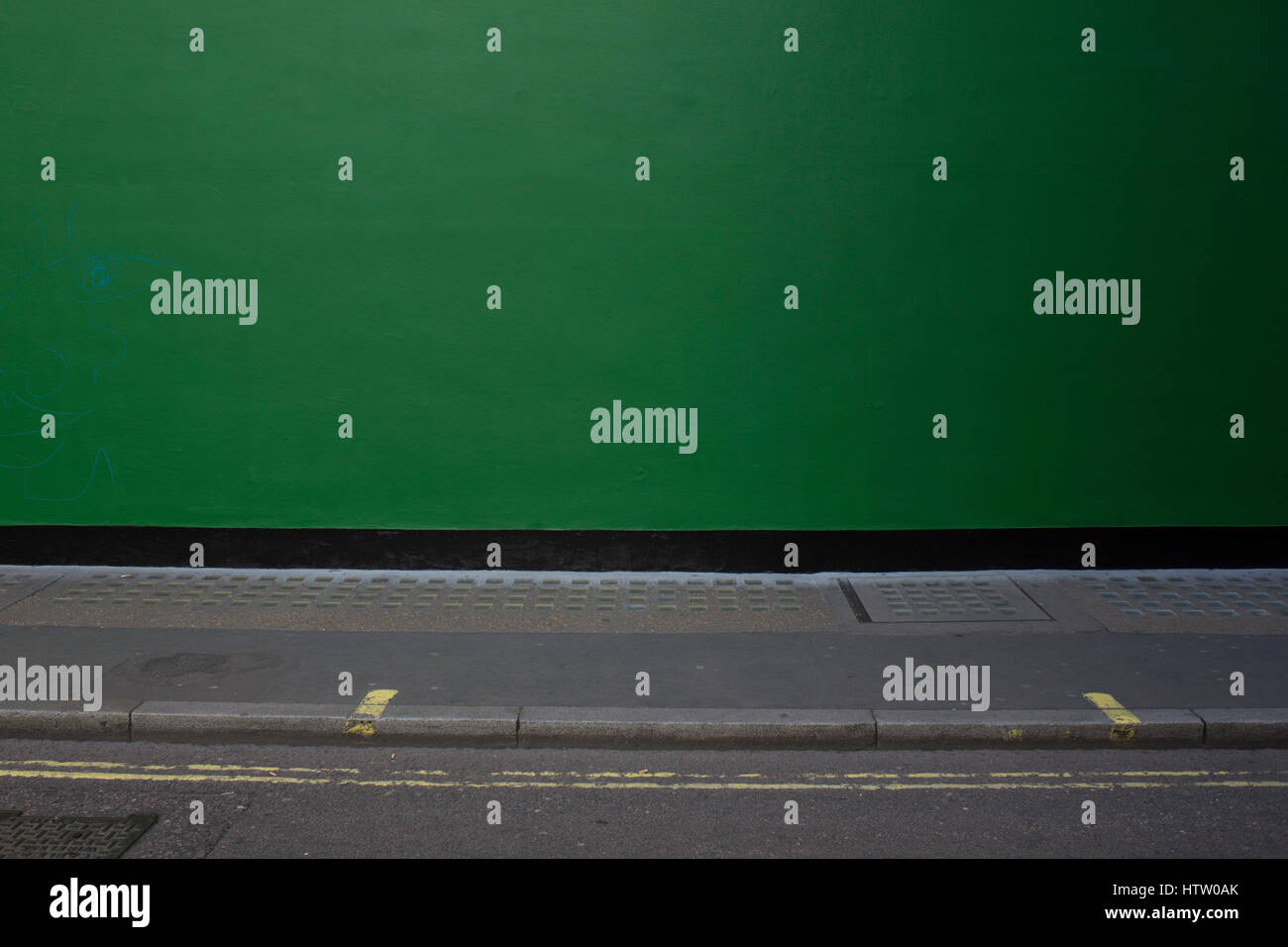 Empty street Scene by a green painted wall on in Soho, London, England ...