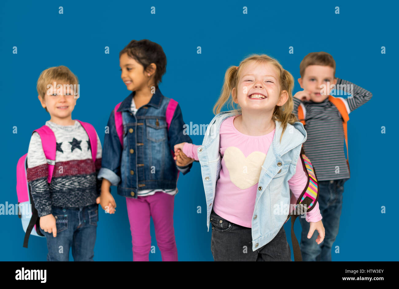 Little Kids Holding Hands Carrying Backpacks Stock Photo - Alamy