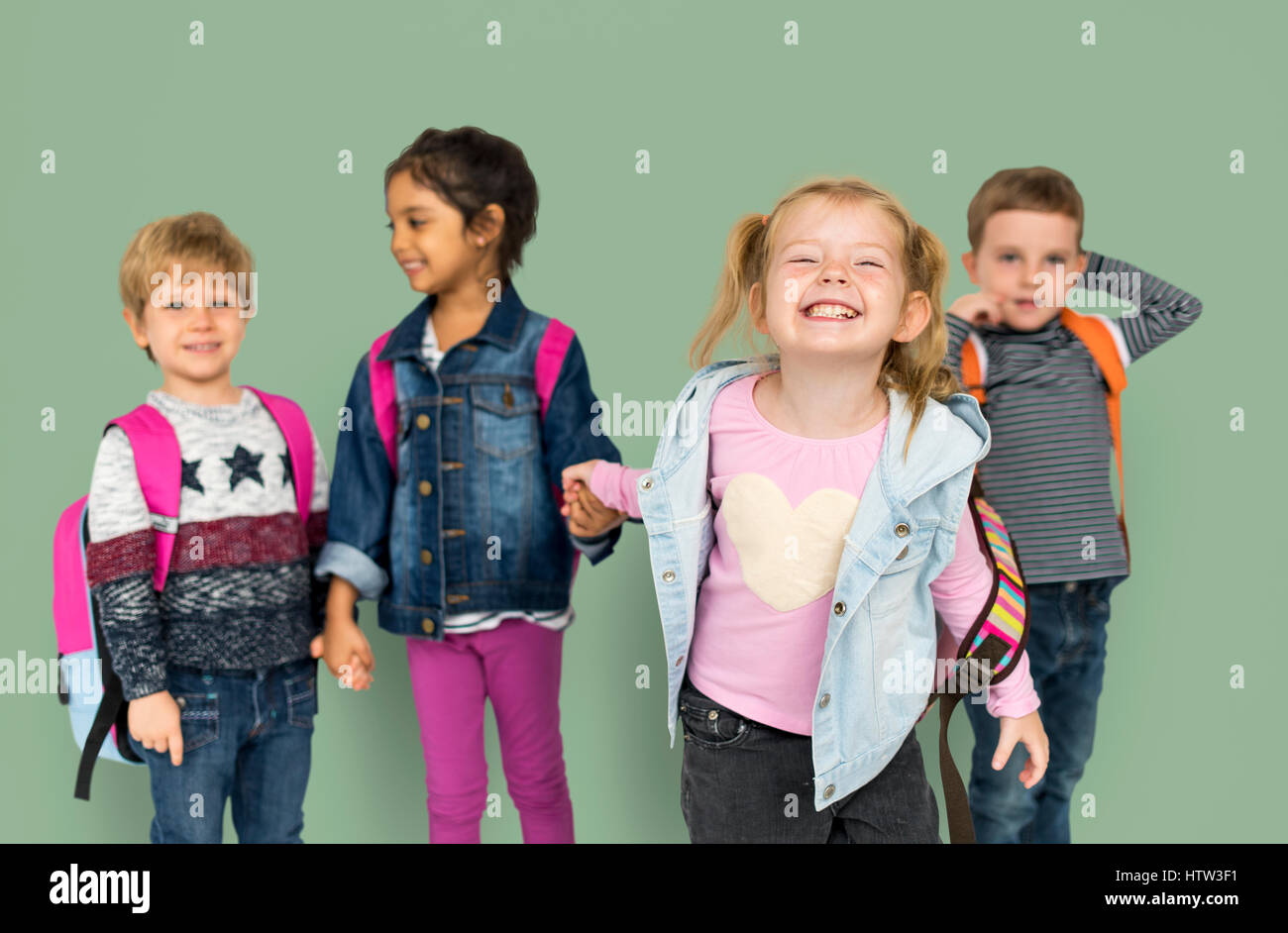 Little Kids Holding Hands Carrying Backpacks Stock Photo - Alamy