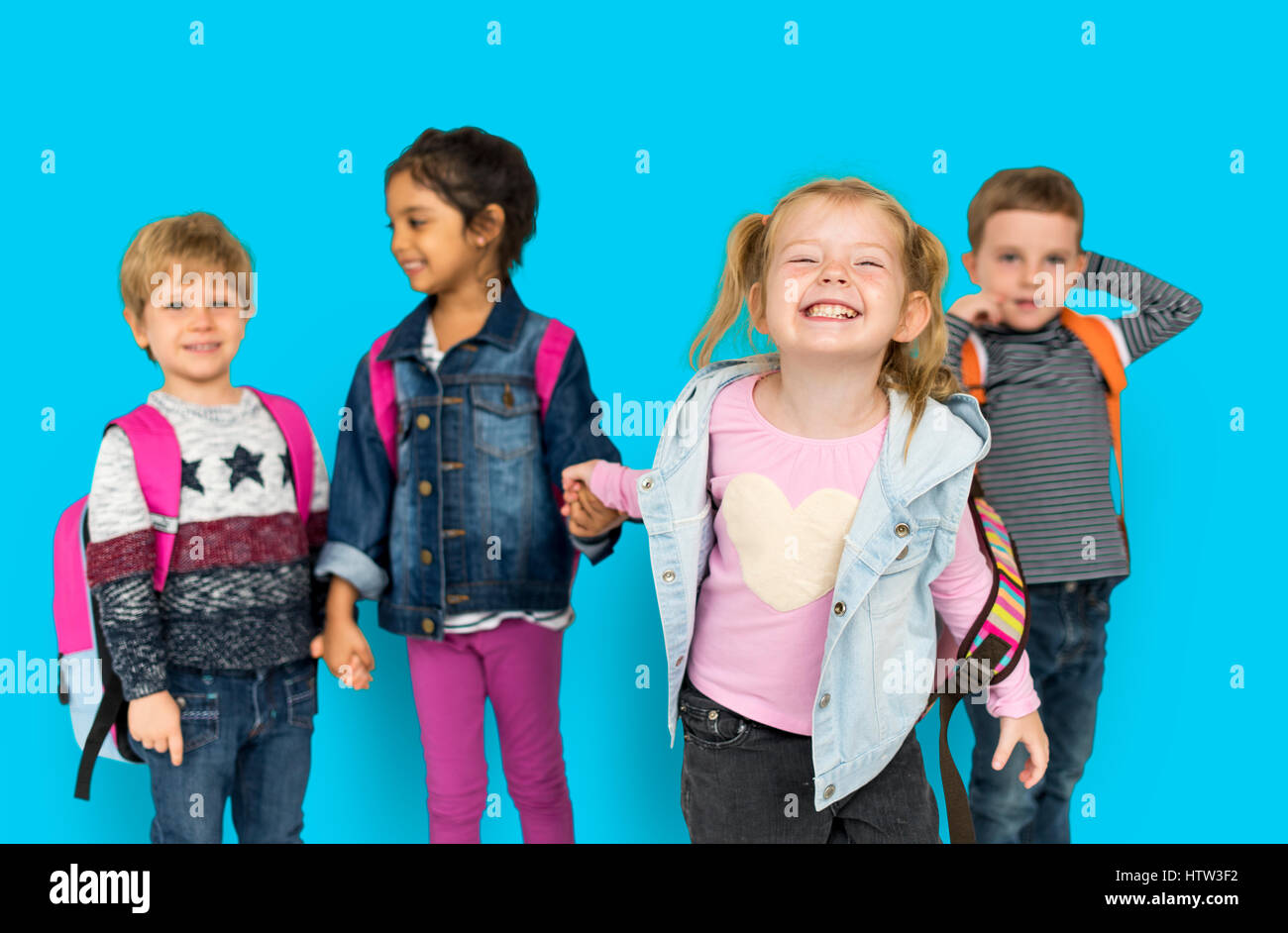 Little Kids Holding Hands Carrying Backpacks Stock Photo - Alamy
