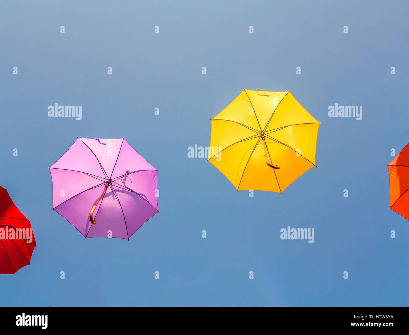 Colorful umbrellas floating against a blue sky Stock Photo - Alamy