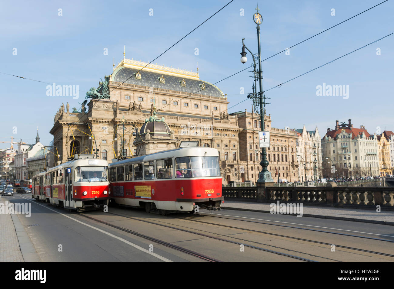 Old and new trams crossing the legion bridge in Prague, with National ...