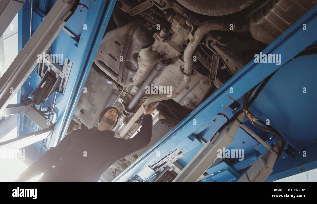Mechanic examining a car Stock Photo - Alamy