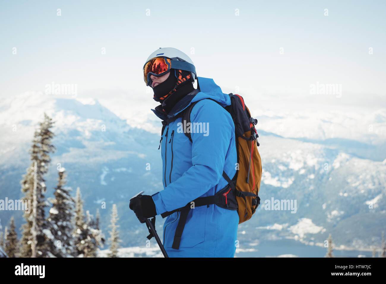 Skier standing at the ski slope holding ski hi-res stock photography ...