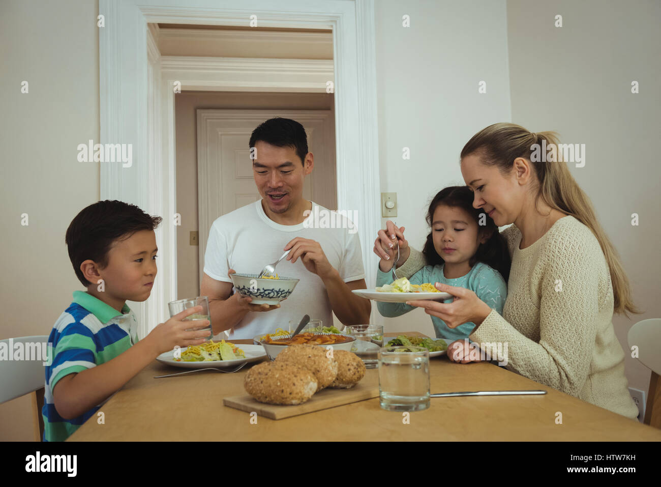 Family having meal on dining table at home Stock Photo - Alamy