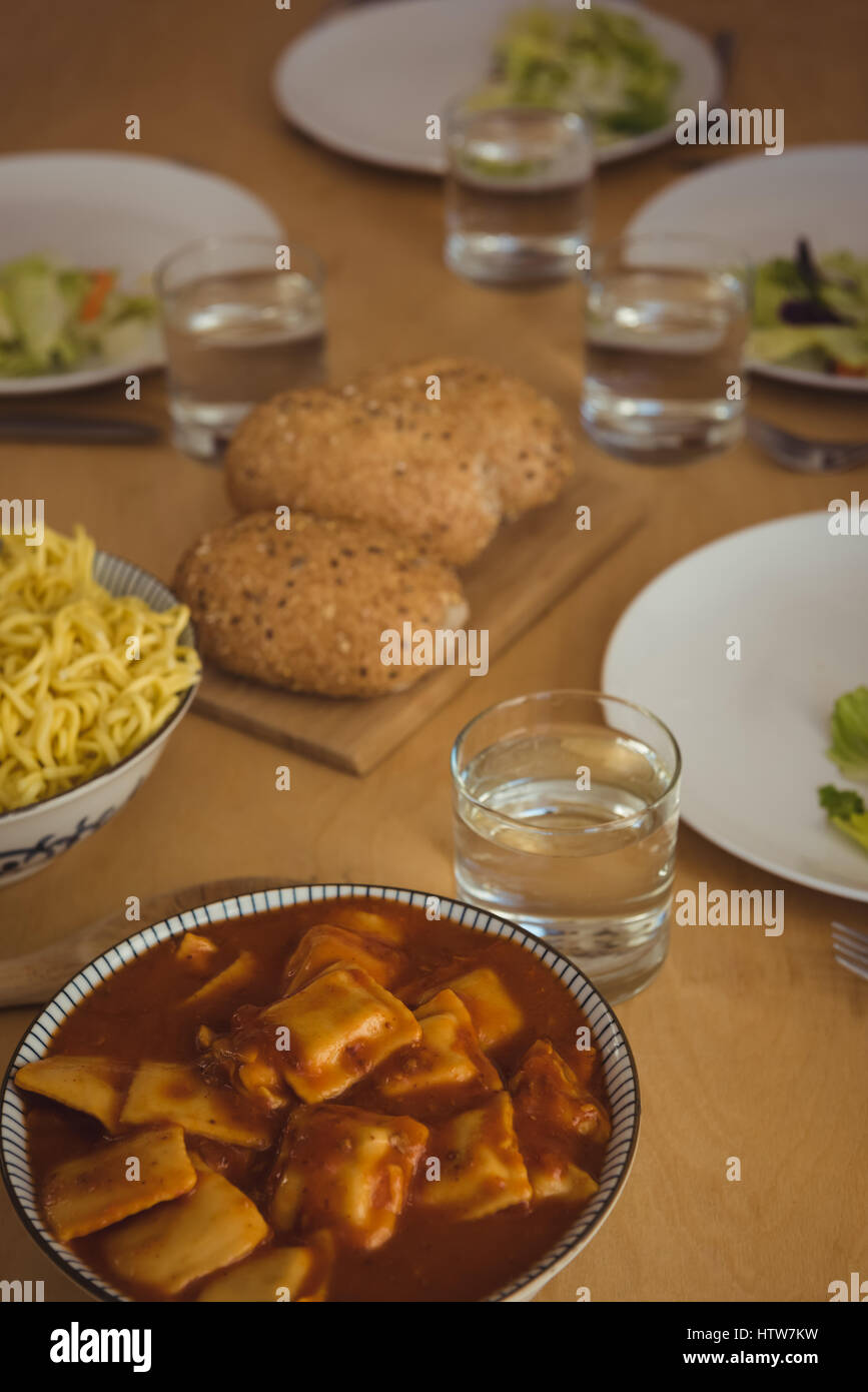 Variety of foods on dining table Stock Photo - Alamy