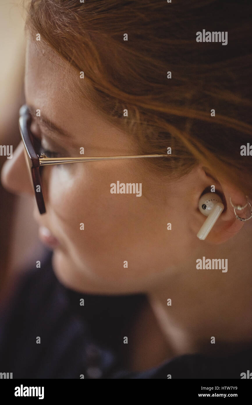 Beautiful woman with wireless earphones Stock Photo - Alamy