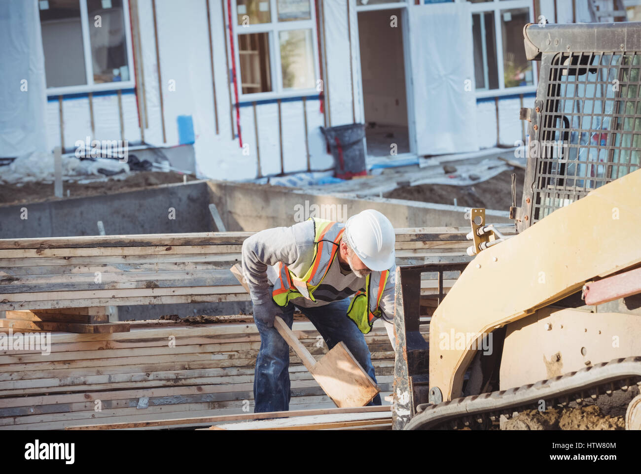 Construction worker working at construction site Stock Photo - Alamy