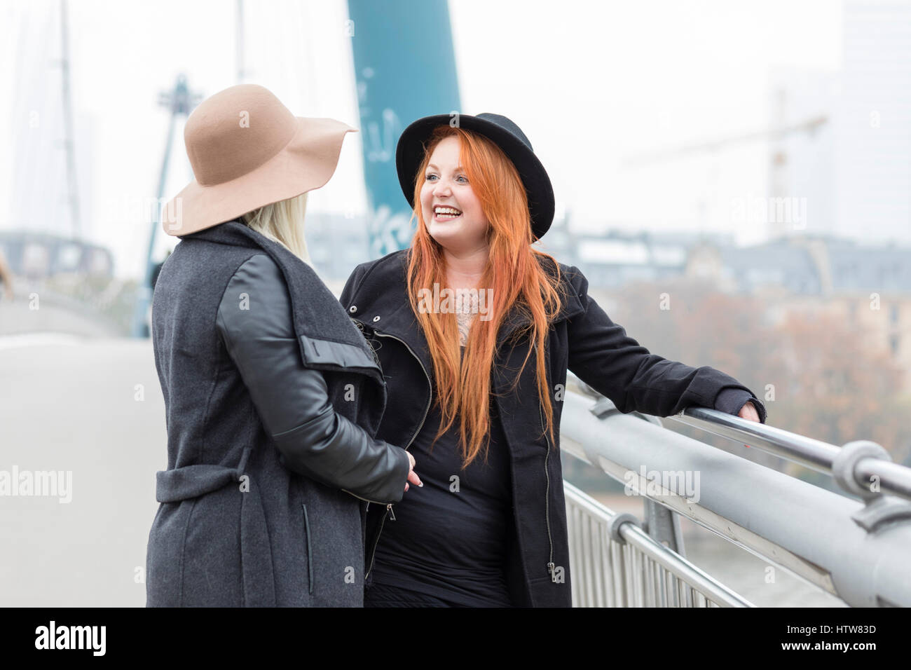 Friends laughing together on a bridge Stock Photo - Alamy
