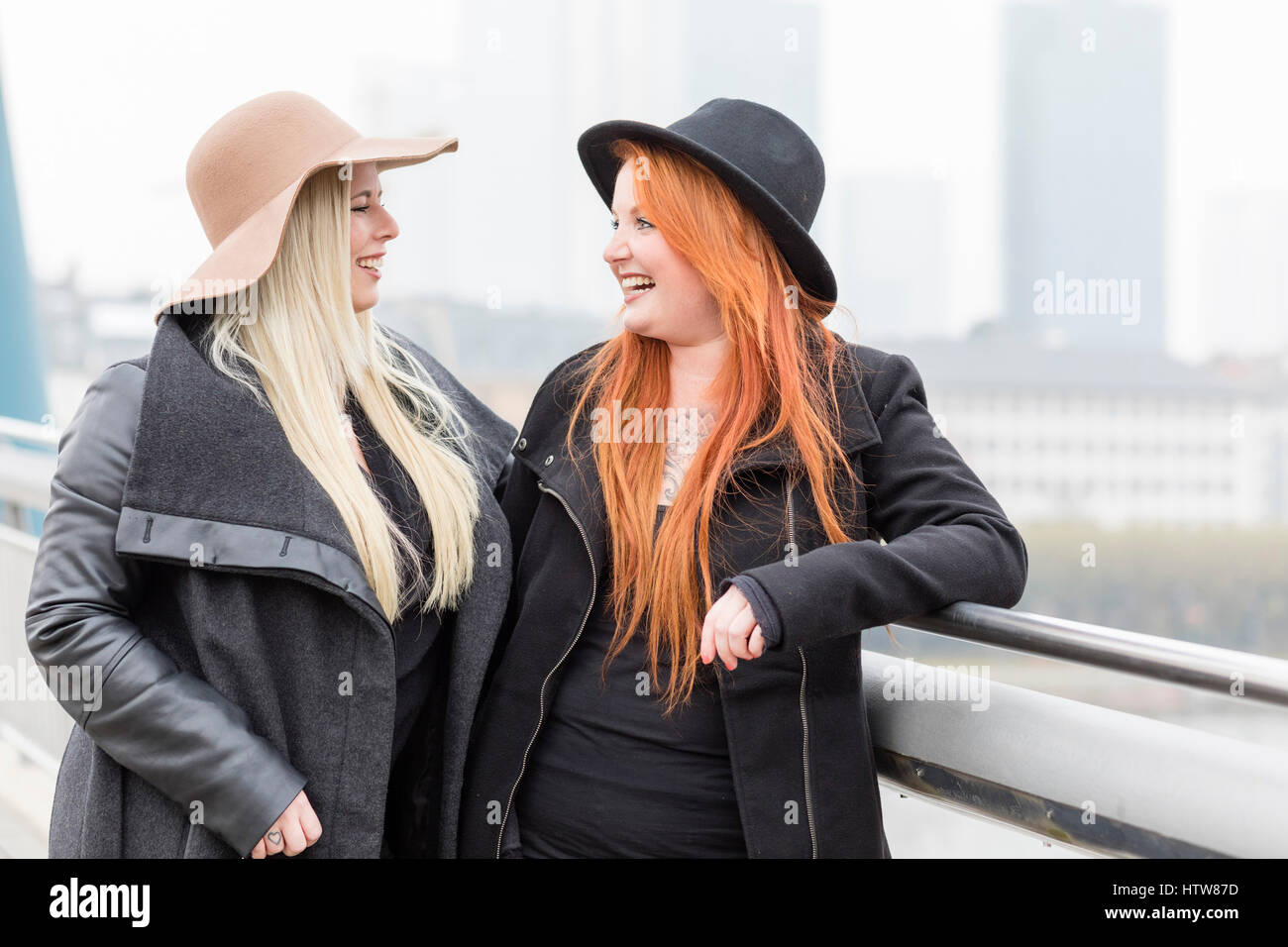 Friends laughing together on a bridge Stock Photo - Alamy