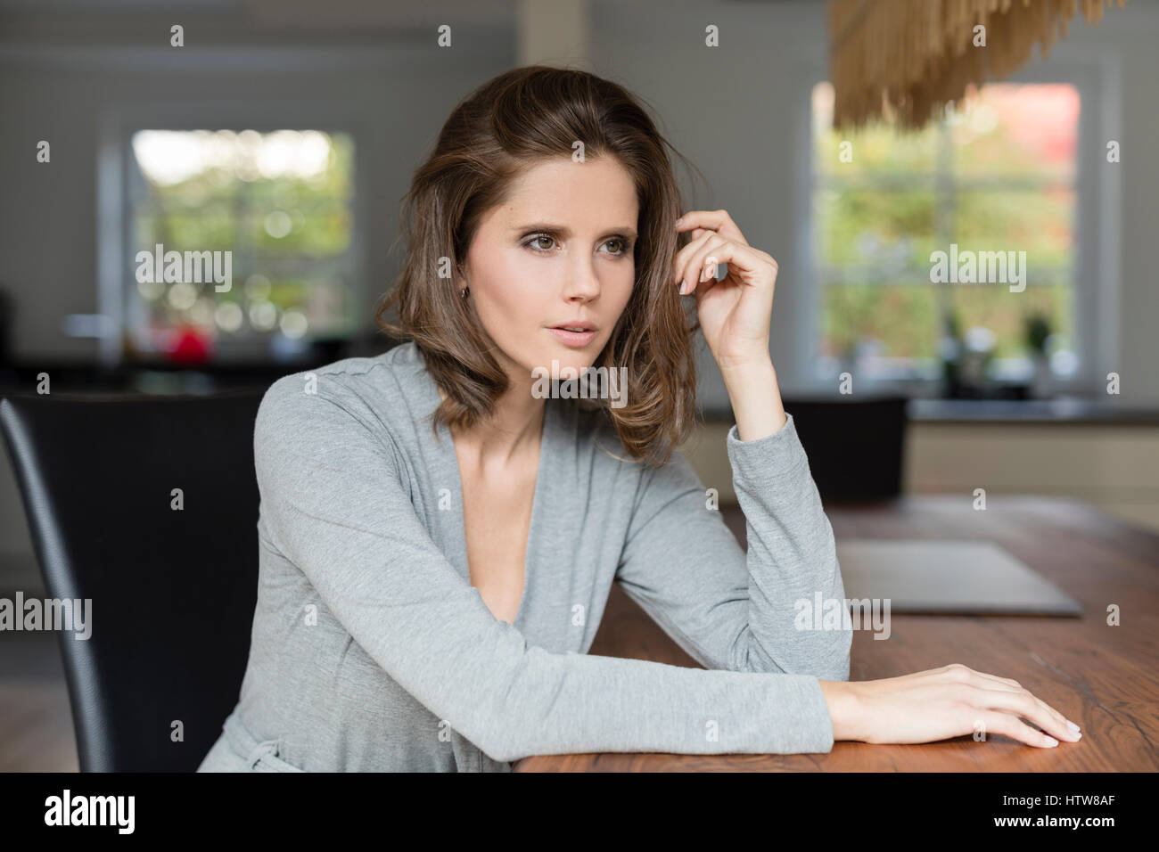 Young woman sitting dining table hi-res stock photography and images ...
