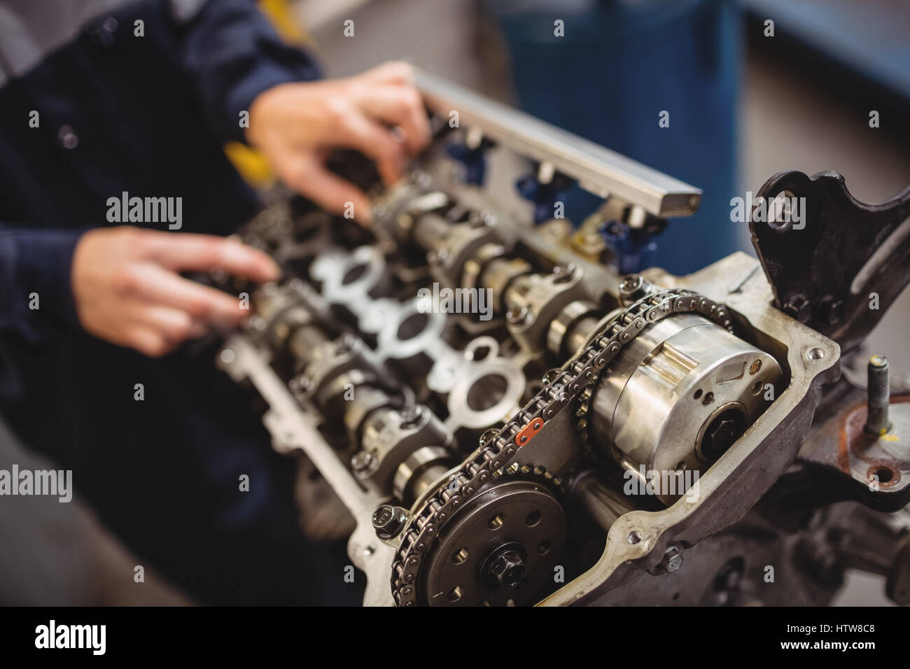 Mid-section of female mechanic checking a car parts Stock Photo - Alamy