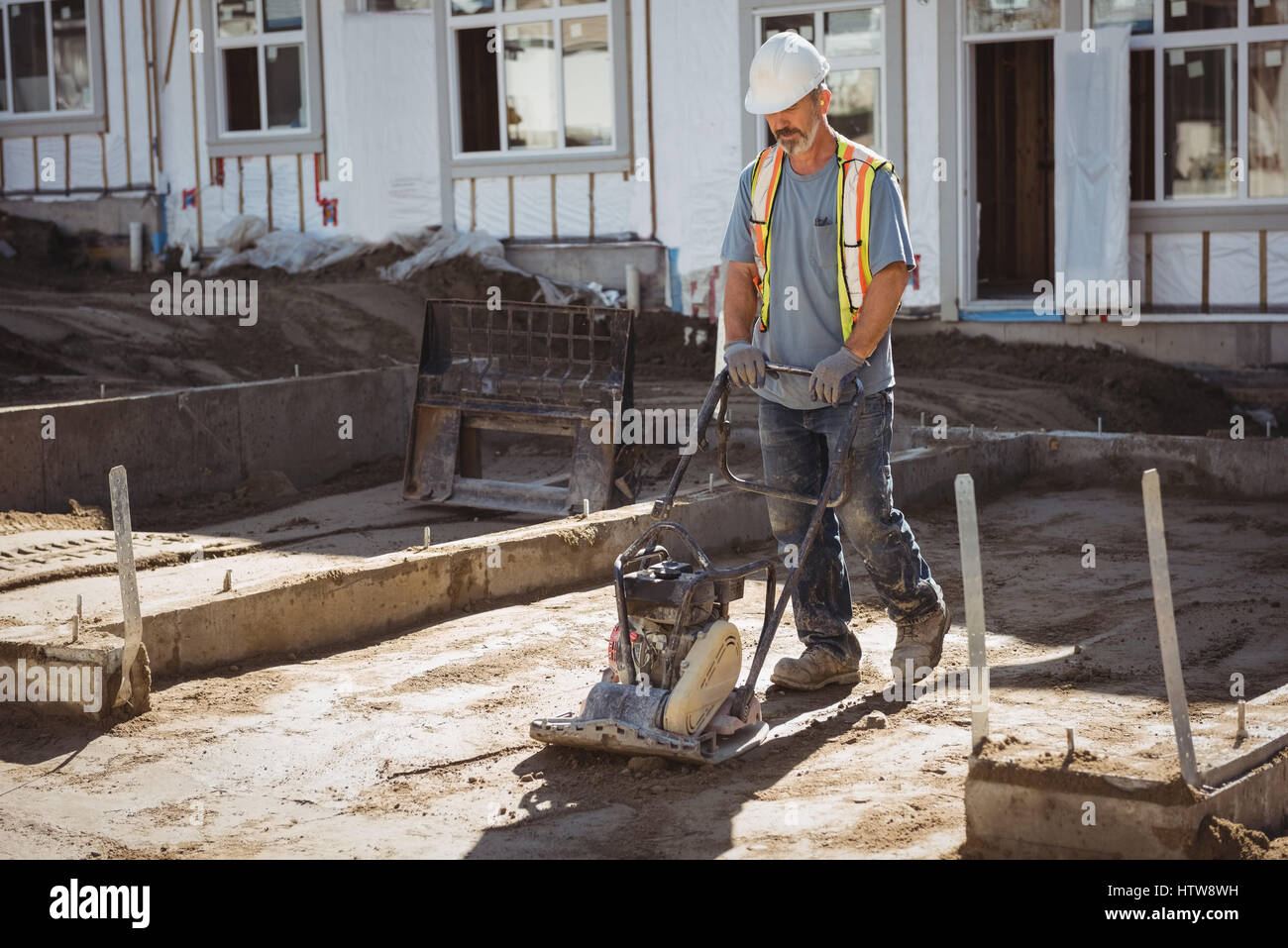 Construction worker working at construction site Stock Photo - Alamy