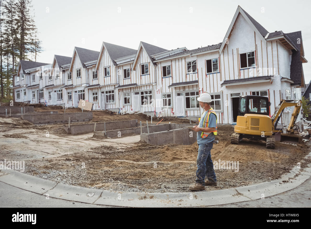 Construction worker holding digital tablet Stock Photo - Alamy