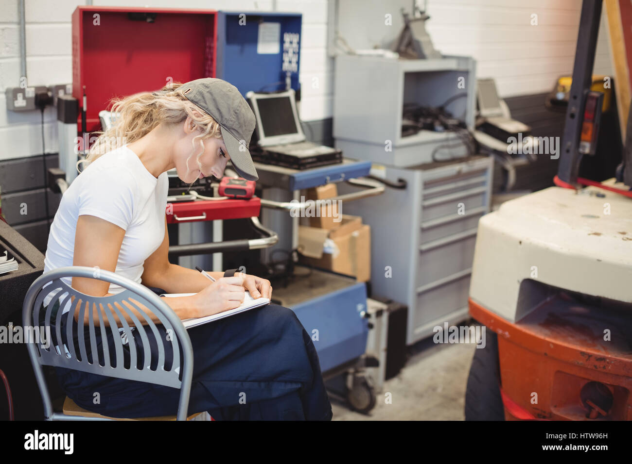 Woman with cap writing hi-res stock photography and images - Alamy
