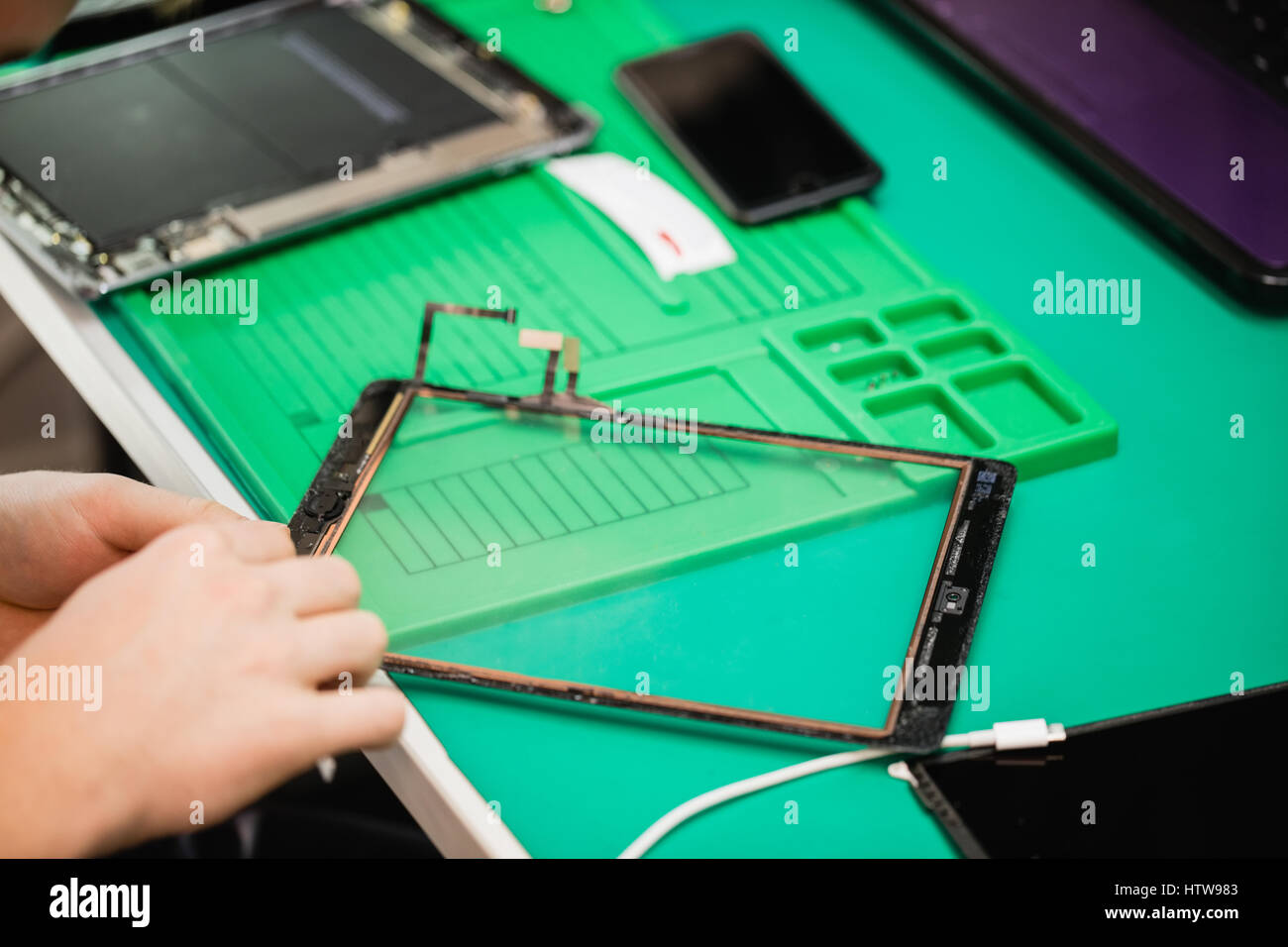 Man repairing digital tablet Stock Photo - Alamy