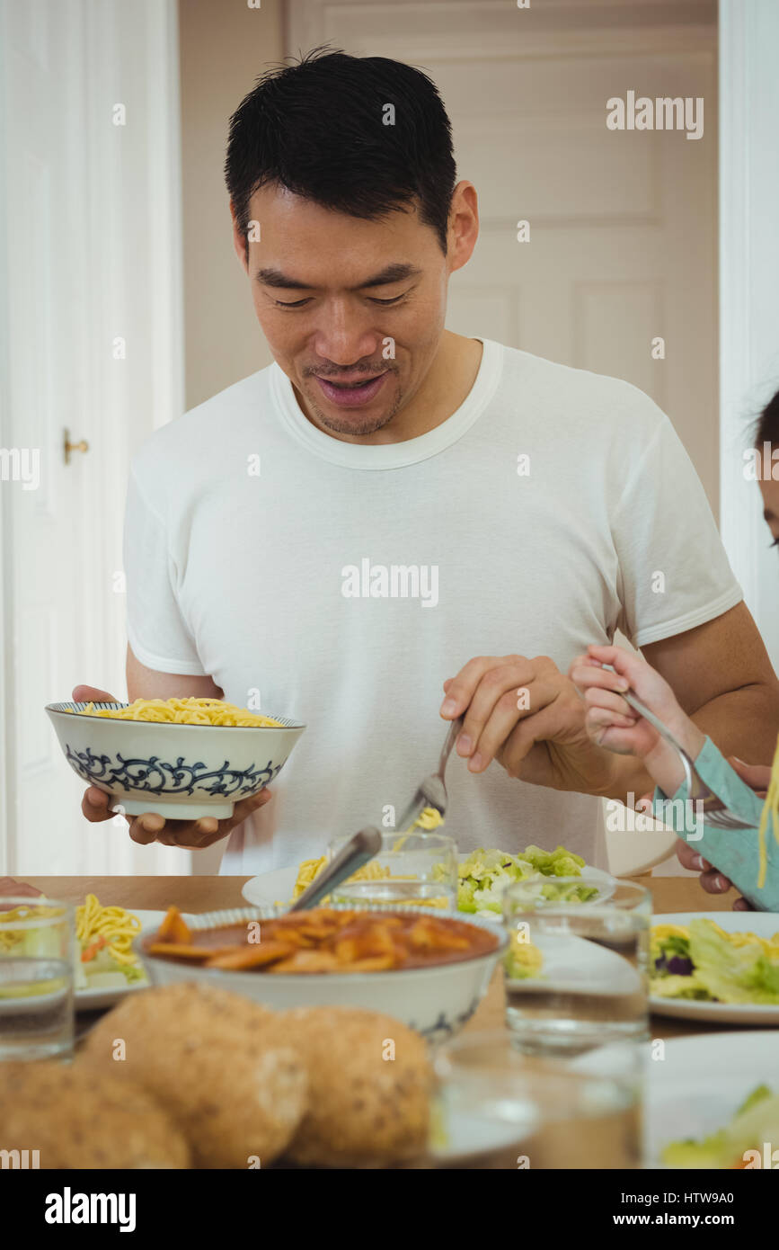 Man having food on dining table Stock Photo - Alamy