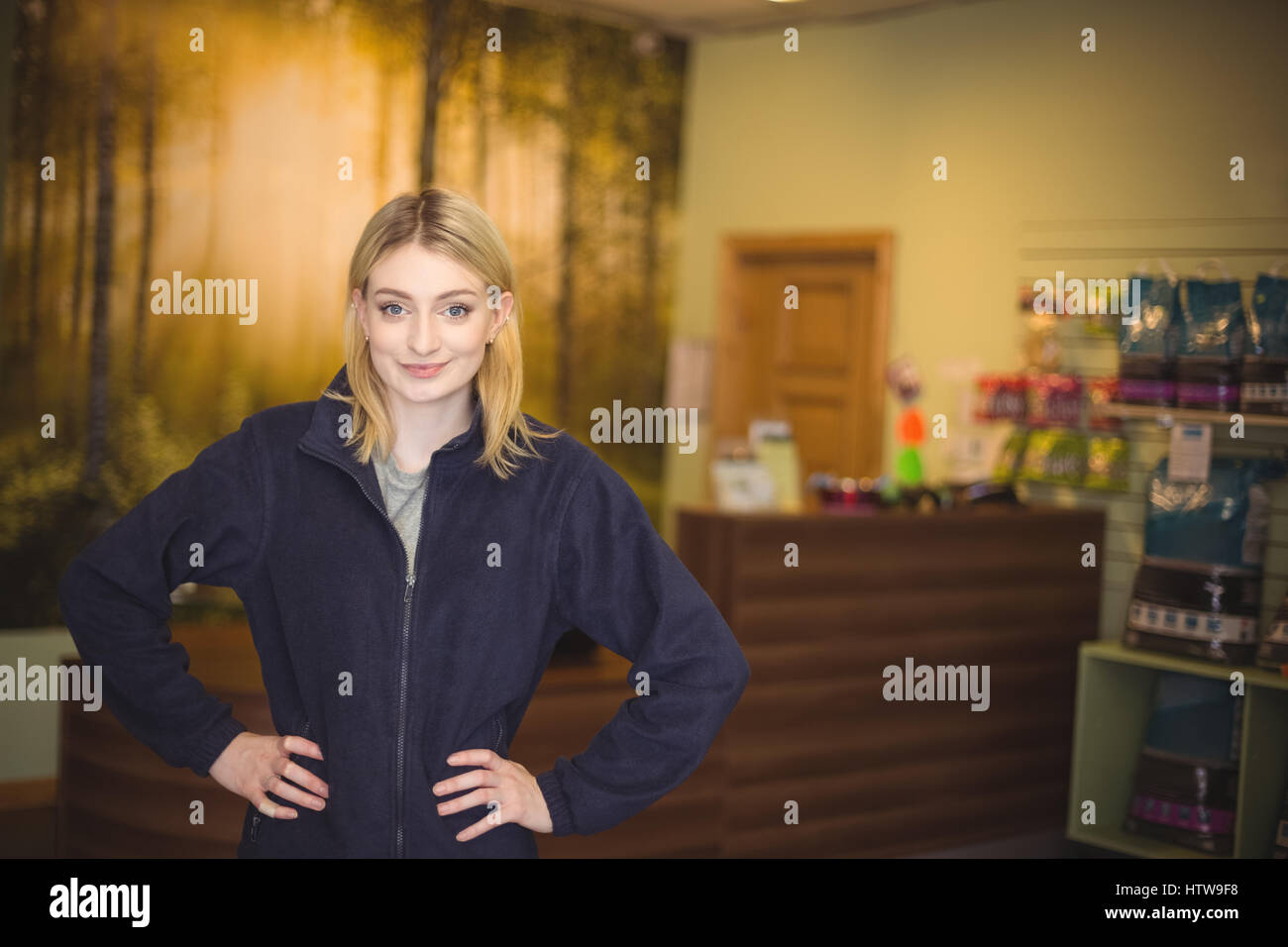 Woman smiling arms akimbo hi-res stock photography and images - Alamy