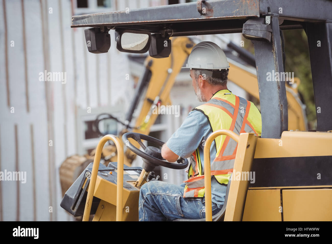 Man operating bulldozer Stock Photo - Alamy