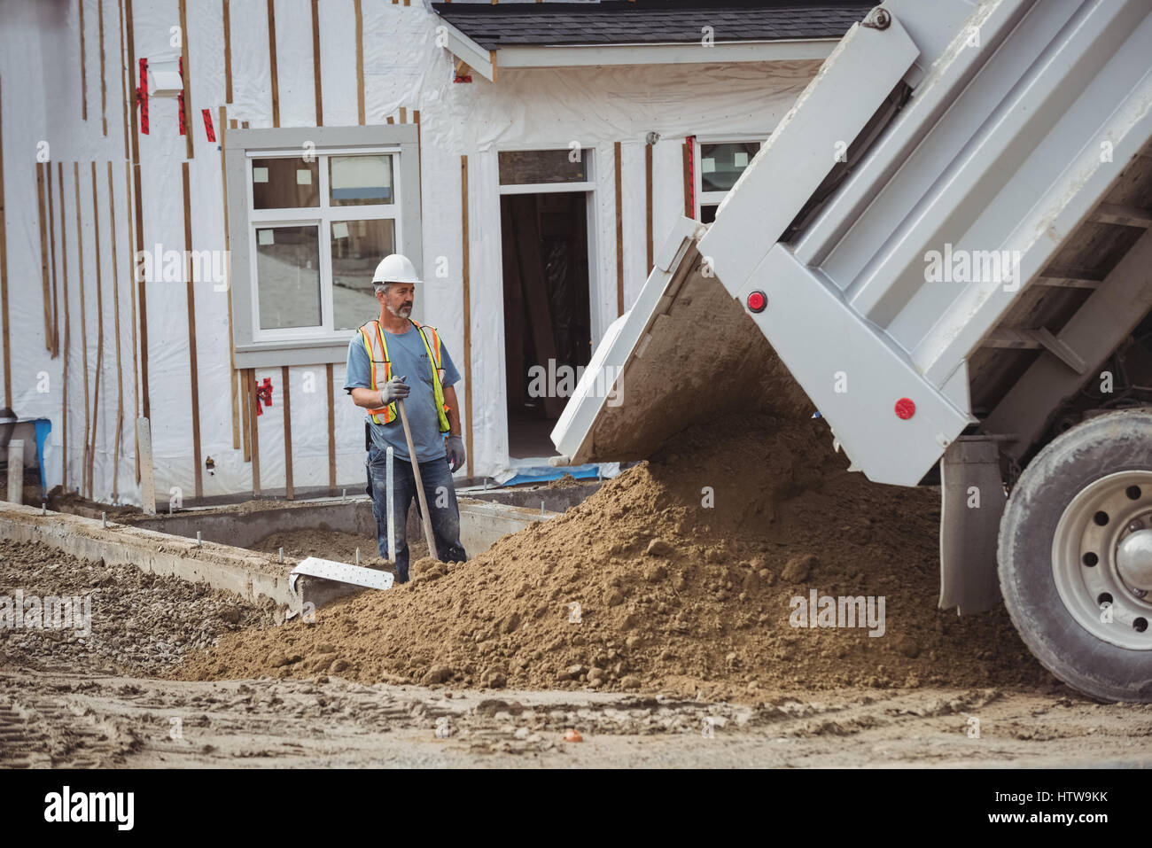 Construction worker working at construction site Stock Photo - Alamy