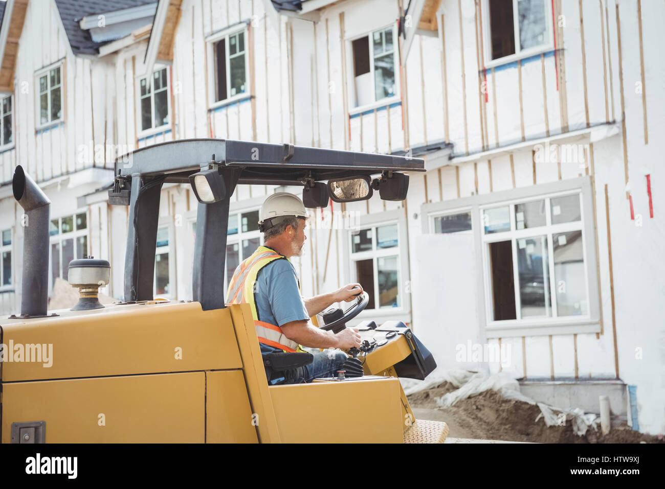 Man operating bulldozer Stock Photo - Alamy