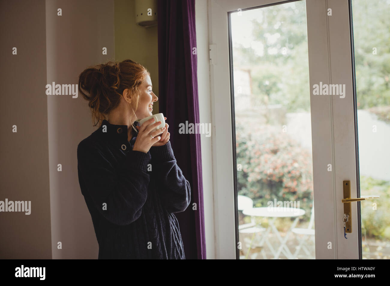 Smiling woman having coffee Stock Photo - Alamy