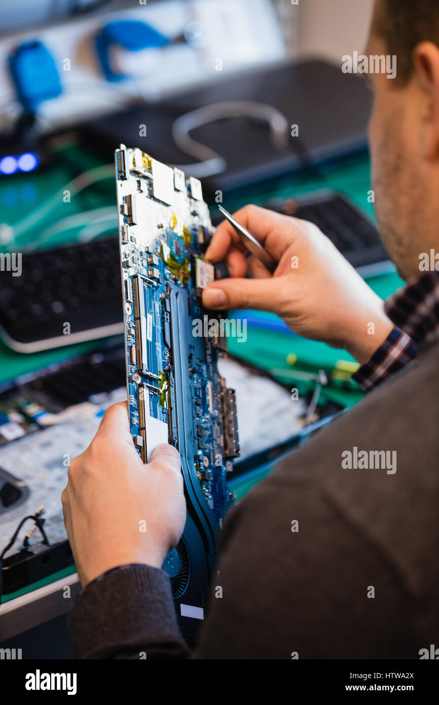 Man repairing laptop Stock Photo - Alamy