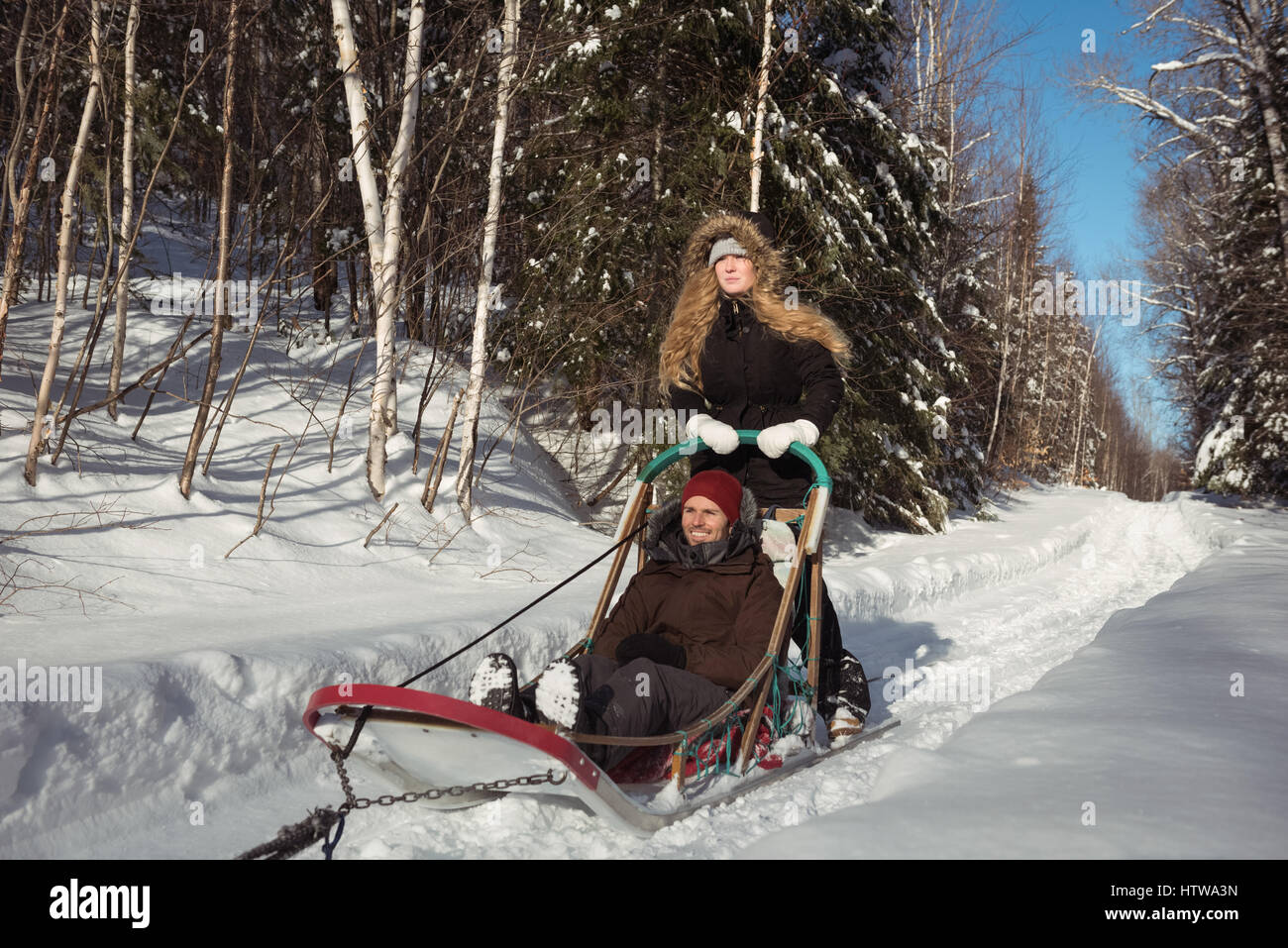 Couple riding the sledge Stock Photo - Alamy