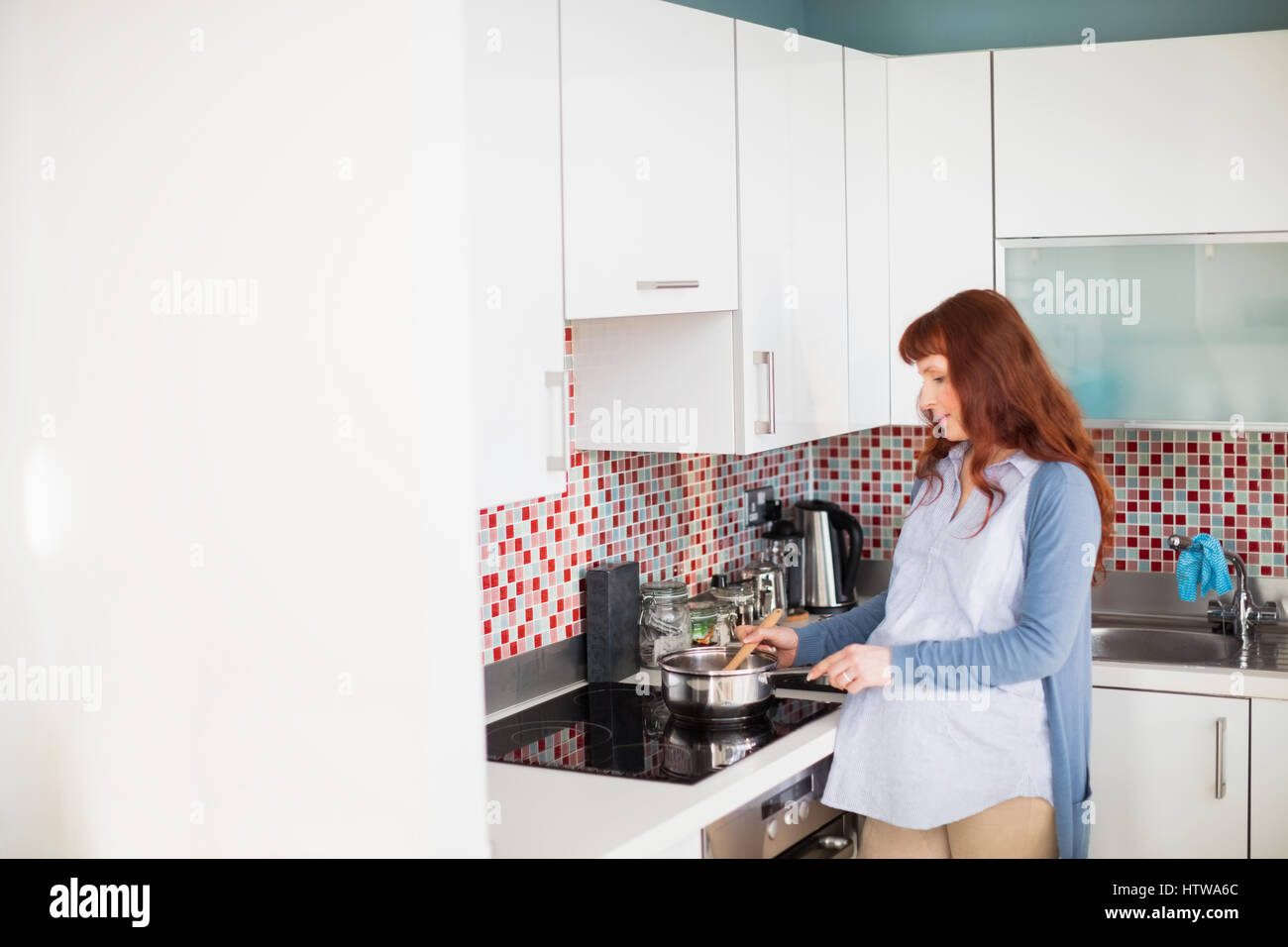 Woman cooking with gas kitchen hi-res stock photography and images - Alamy