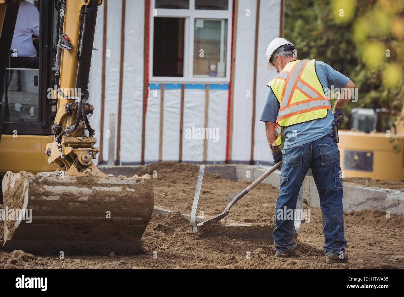 Construction worker working at construction site Stock Photo - Alamy