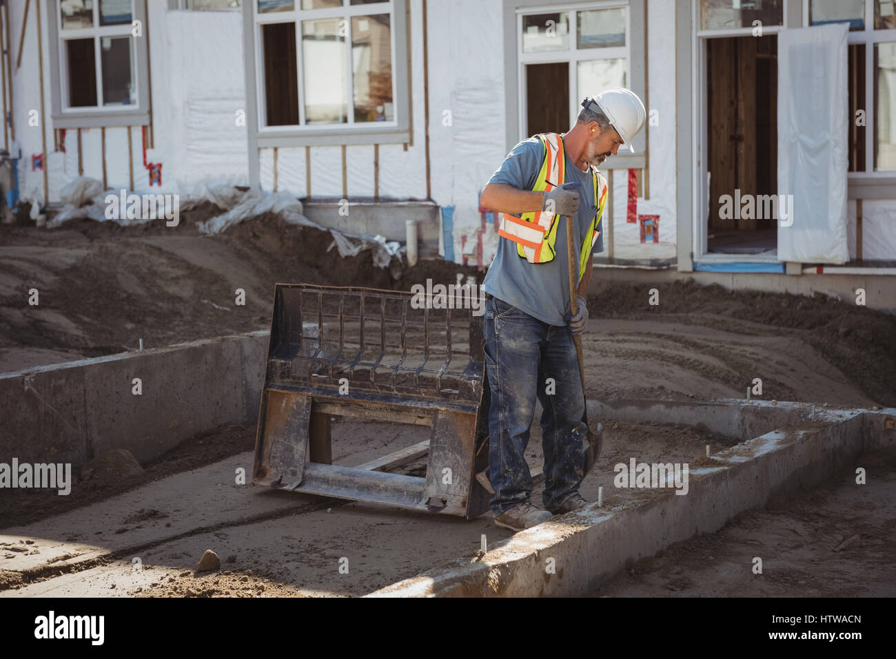 Construction worker working at construction site Stock Photo - Alamy