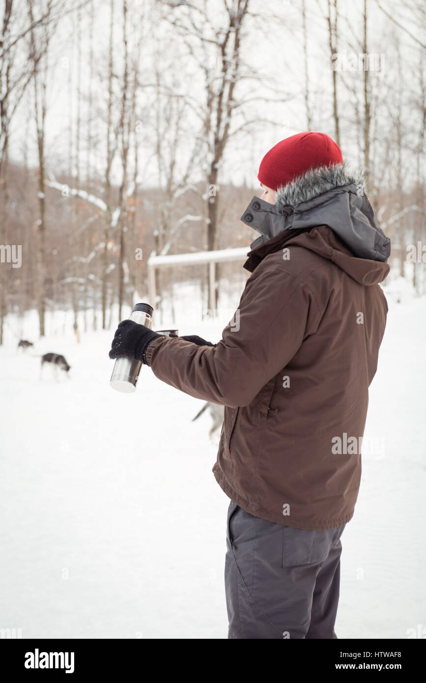 Musher pouring hot drink from thermos Stock Photo - Alamy
