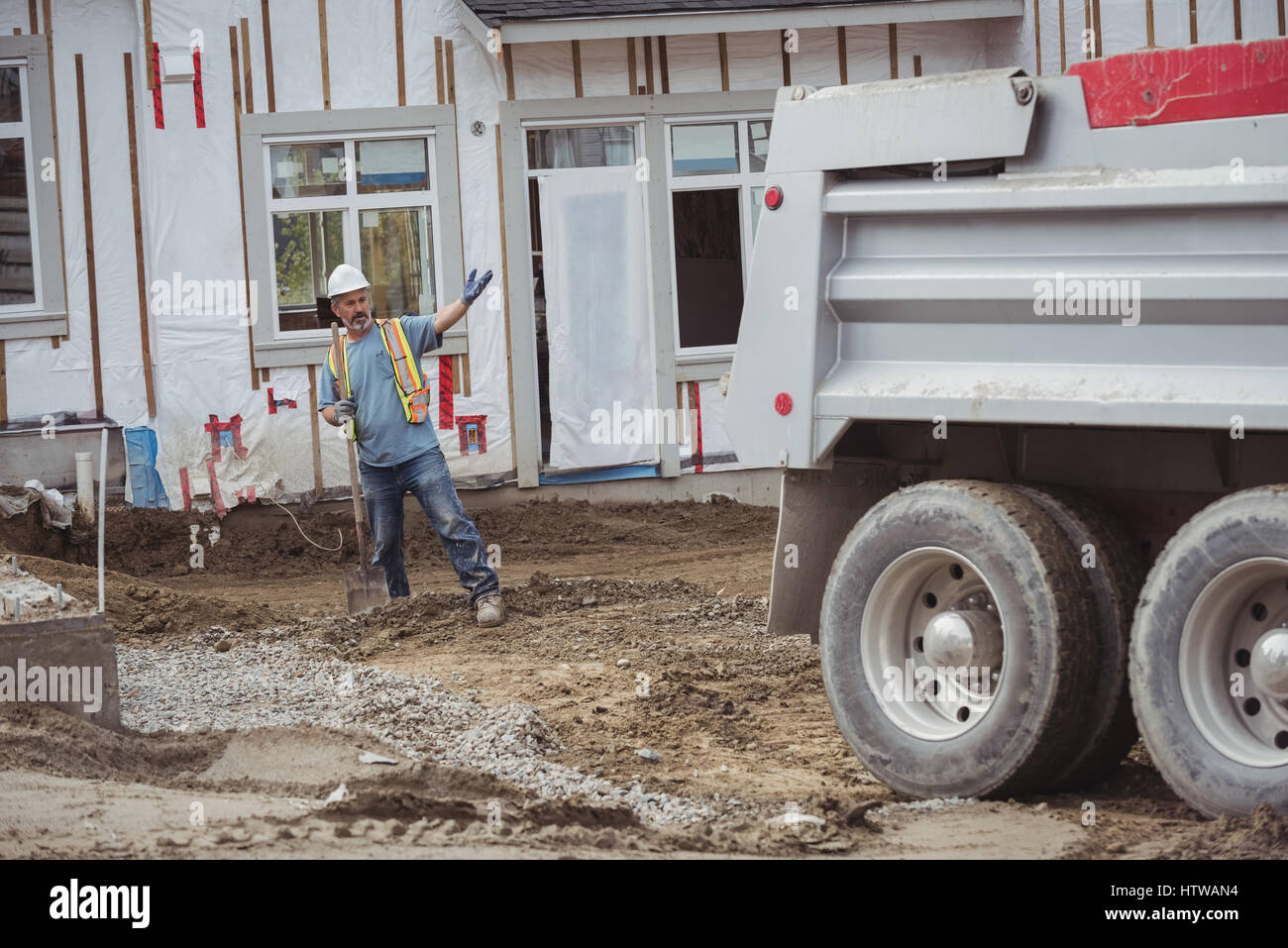 Construction worker working at construction site Stock Photo - Alamy