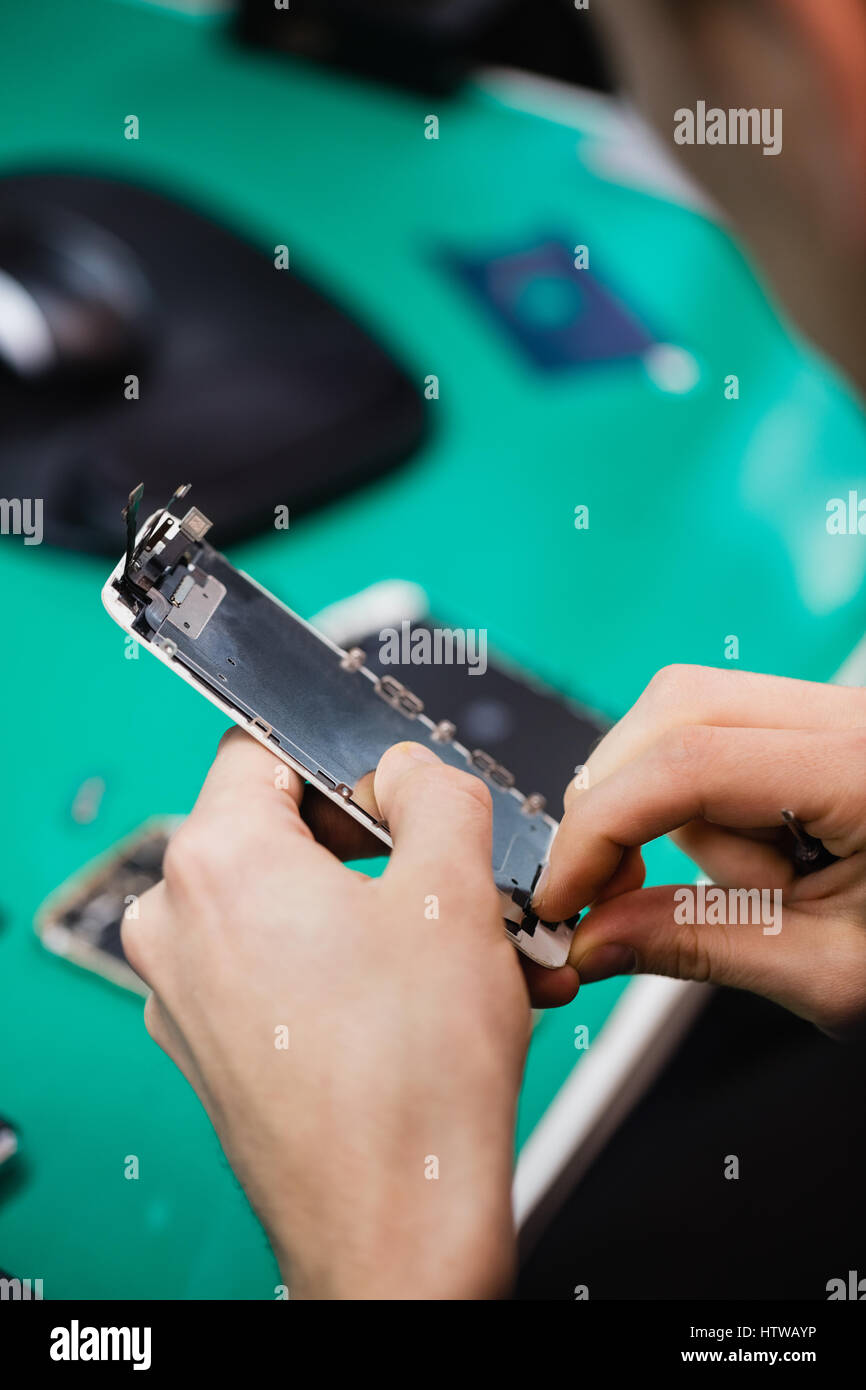 Technician mobile phone repairing fixing hi-res stock photography and ...