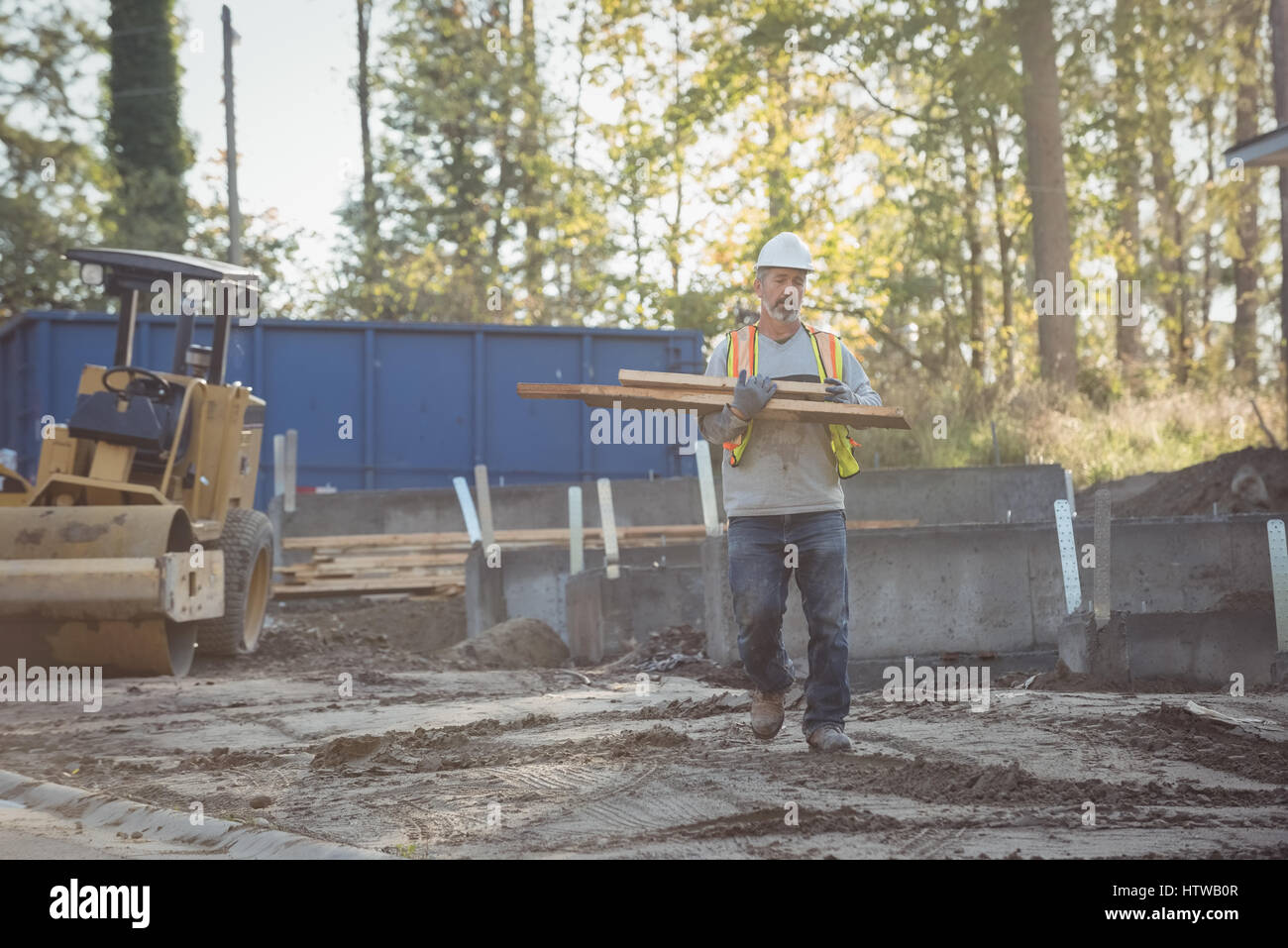 Construction worker working at construction site Stock Photo - Alamy
