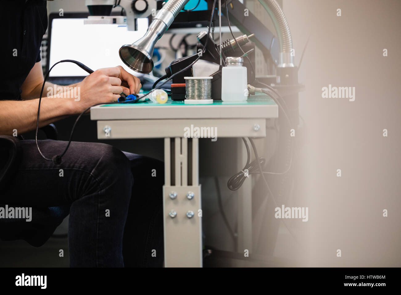 Man repairing an electronic device Stock Photo - Alamy