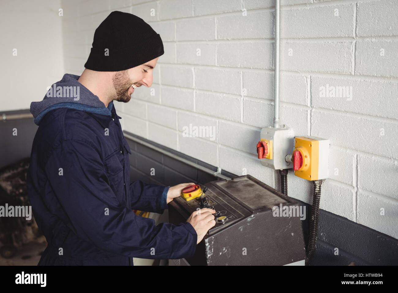Mechanic using control box Stock Photo - Alamy