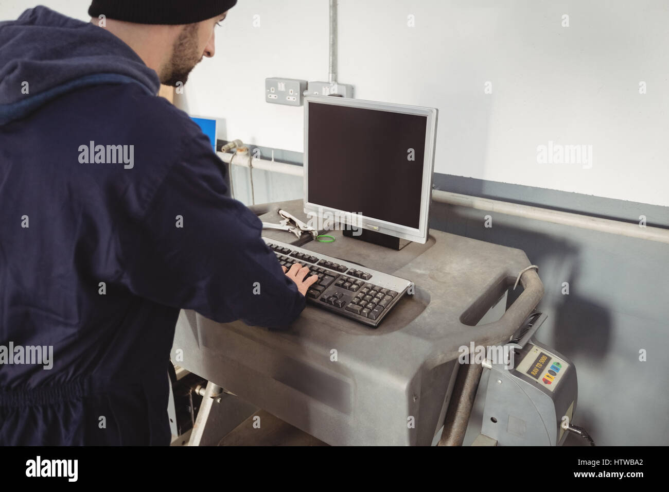 Mechanic working on personal computer Stock Photo - Alamy