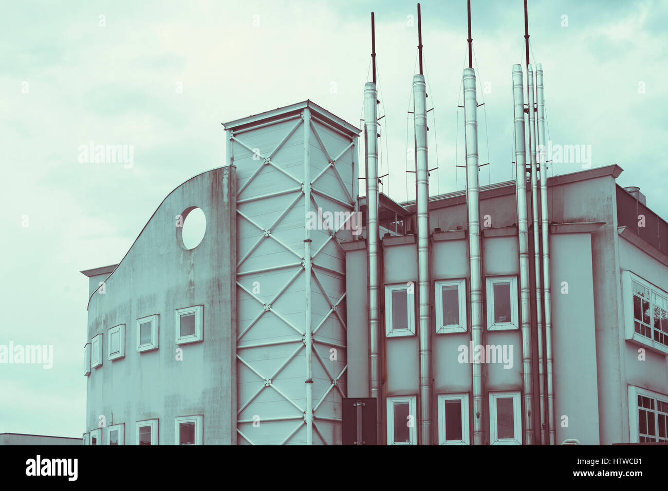 industrial factory building with cloudy sky above Stock Photo - Alamy