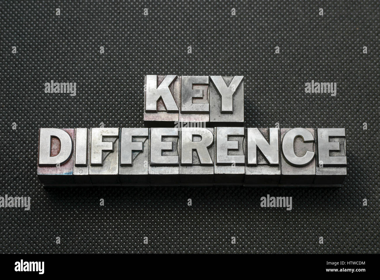 key difference phrase made from metallic letterpress blocks on black ...
