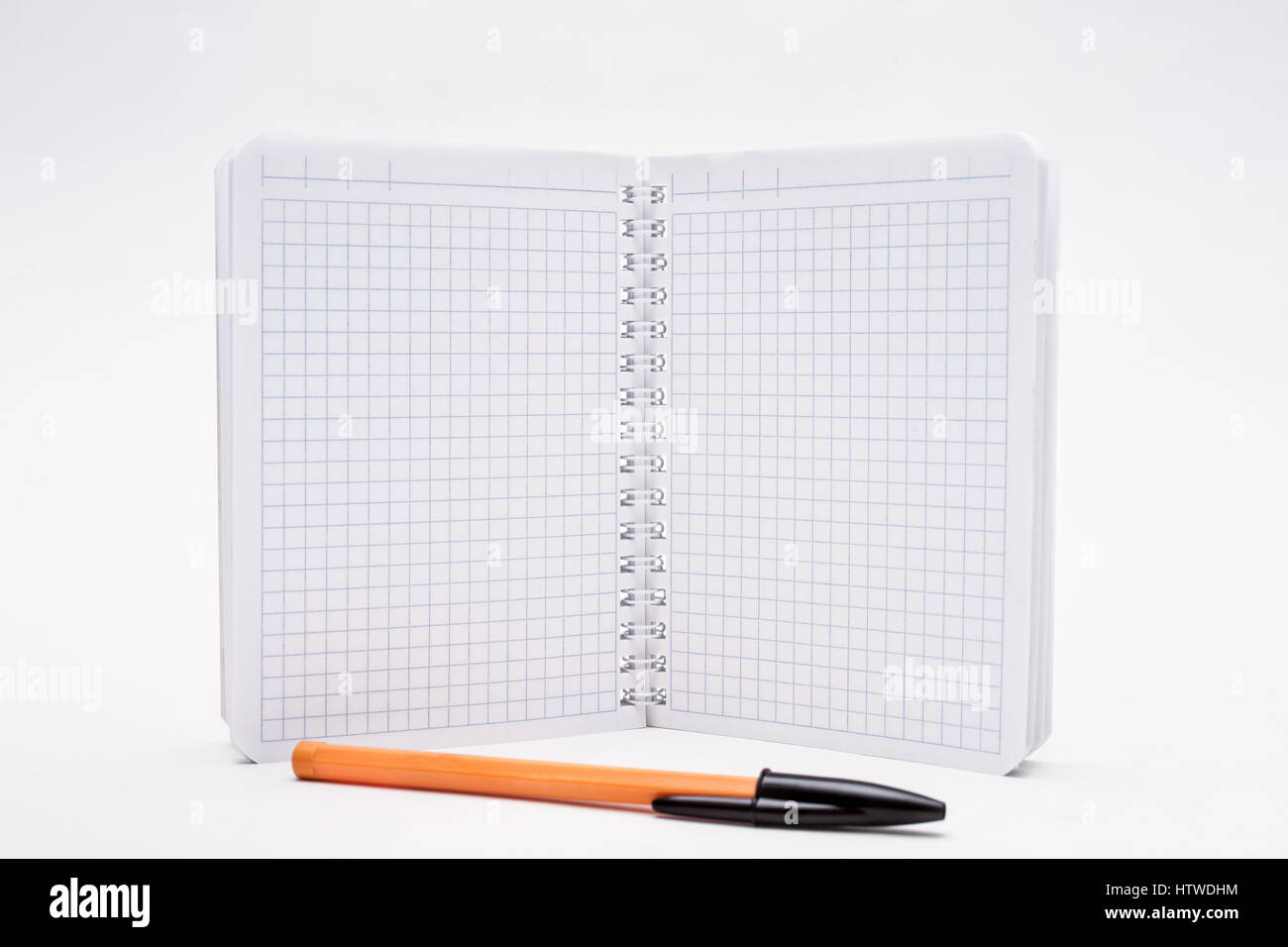 Open notebook and ball pen on a white background Stock Photo - Alamy
