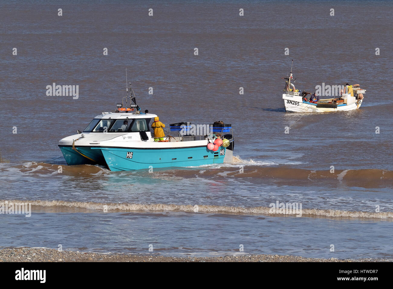 Shell fishing boat towing in smaller boat with engine trouble to the ...