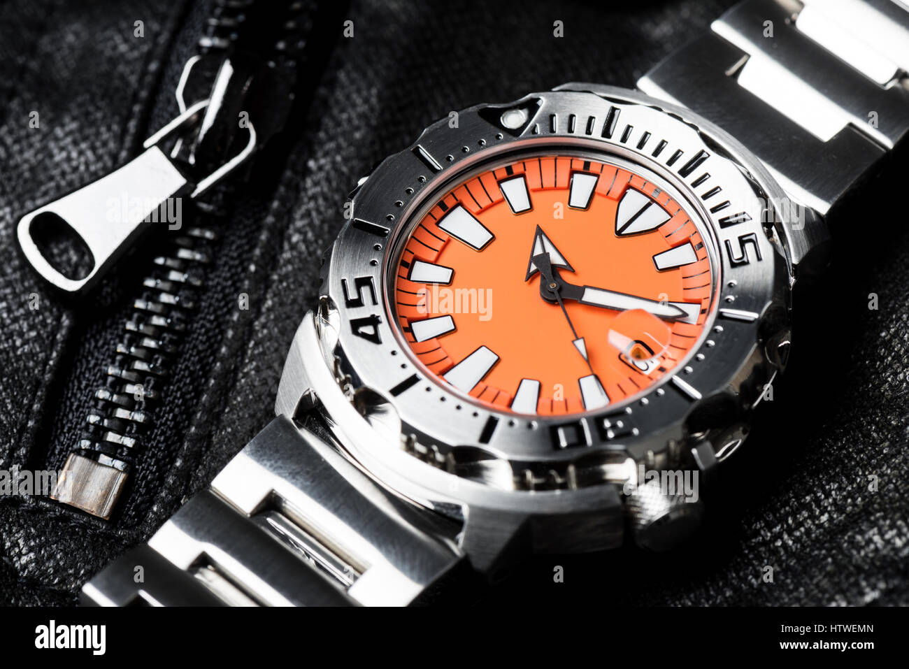 closeup watch for diver with orange dial Stock Photo - Alamy