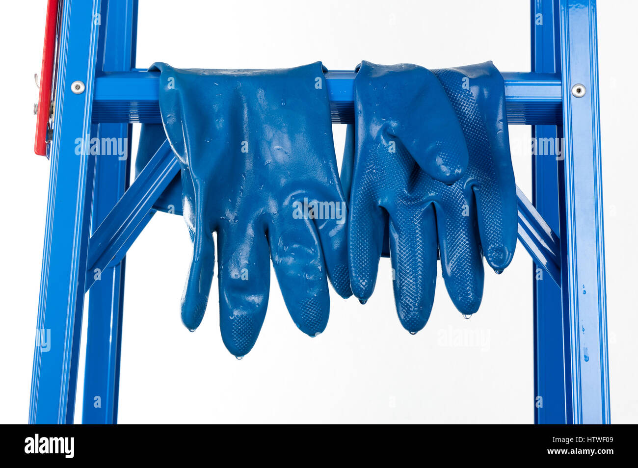 wet blue rubber glove hanging on ladder, personal protection equipment ...