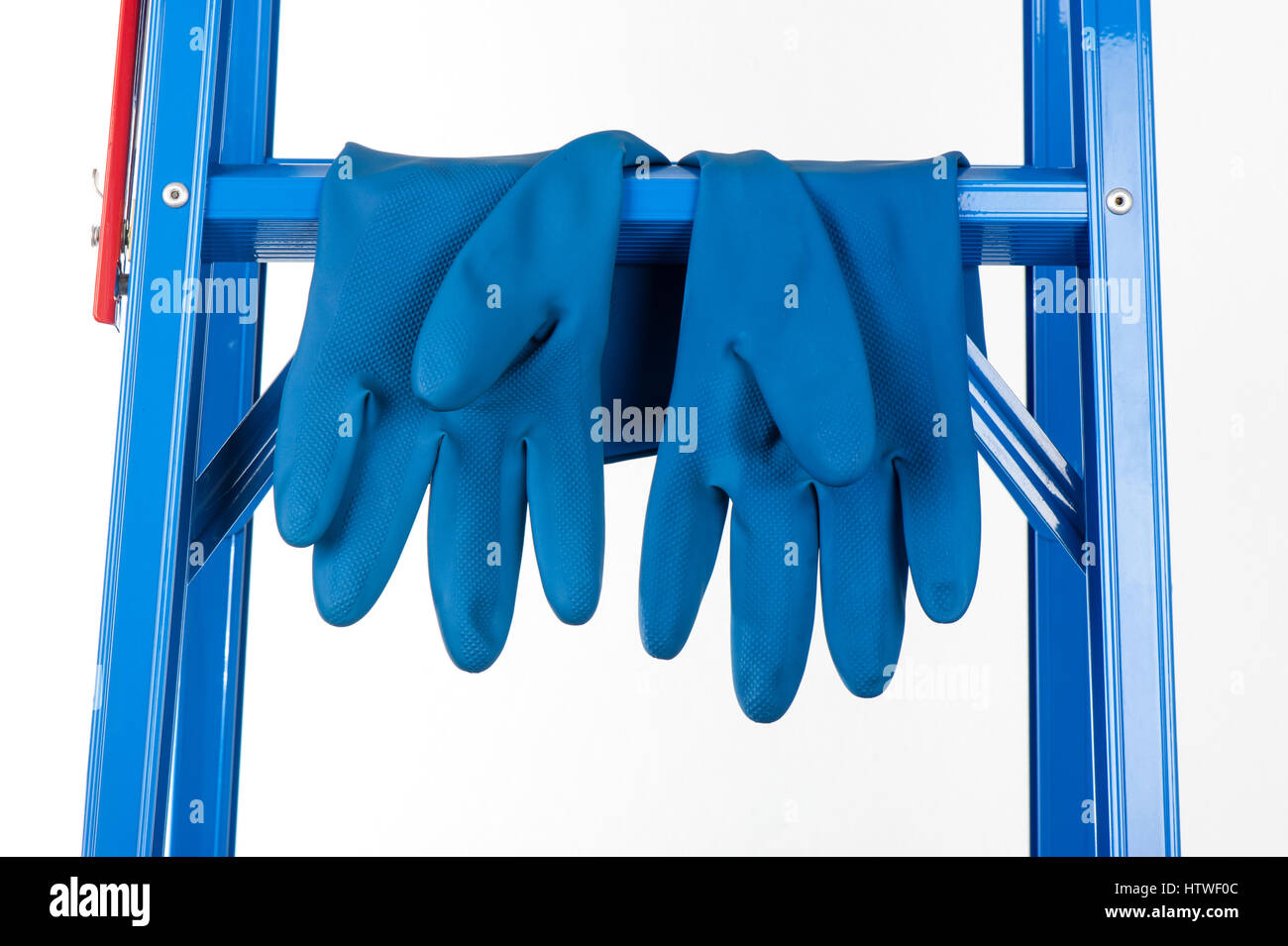 dry blue rubber glove hanging on ladder, personal protection equipment ...