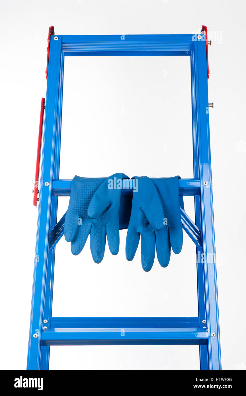 dry blue rubber glove hanging on ladder, personal protection equipment ...