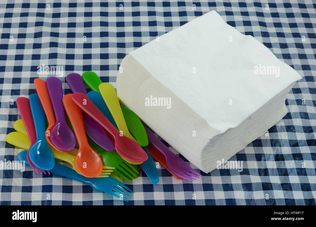 Paper napkins and plastic flatware for picnic party Stock Photo - Alamy