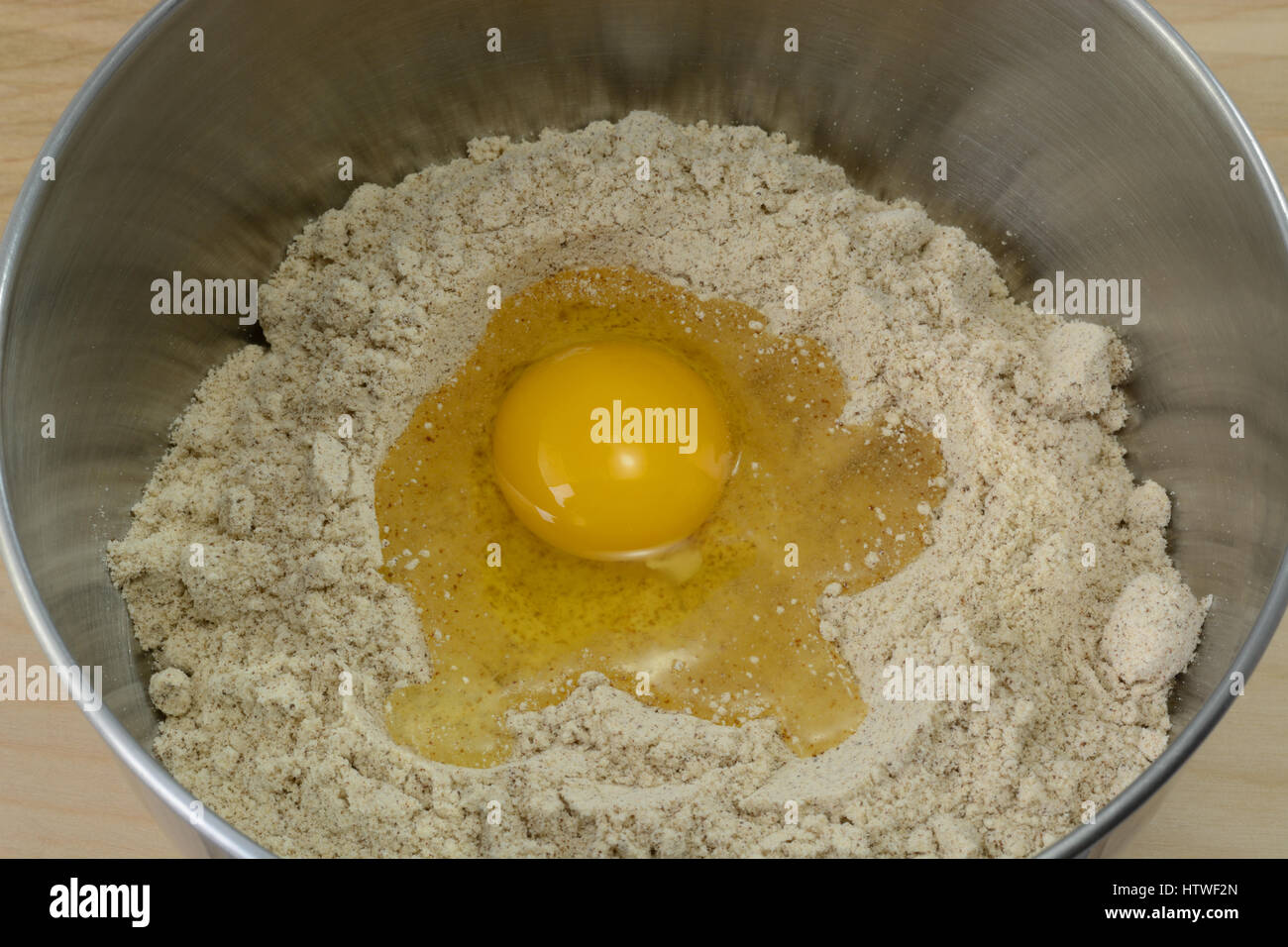 Gingerbread flour dry mix with egg in stainless steel mixing bowl Stock ...