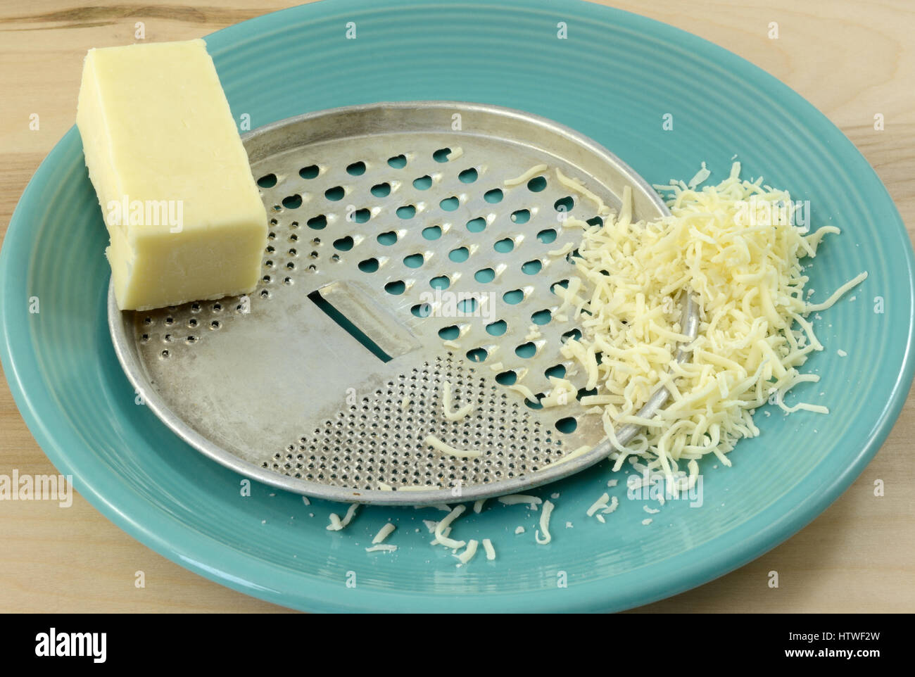 Retro vintage cheese grater with block and shredded mozzarella cheese ...